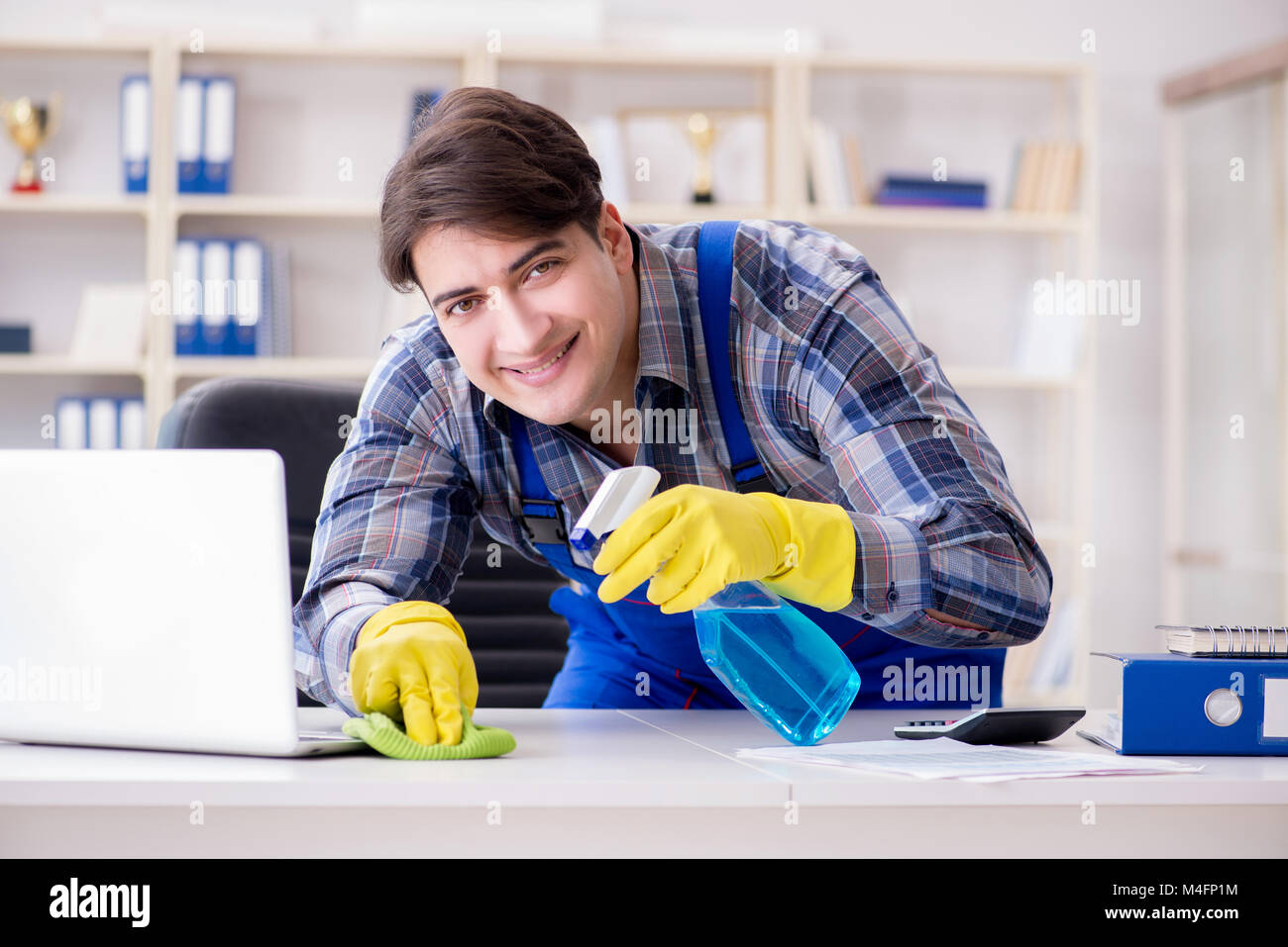 Male cleaner working in the office Stock Photo - Alamy