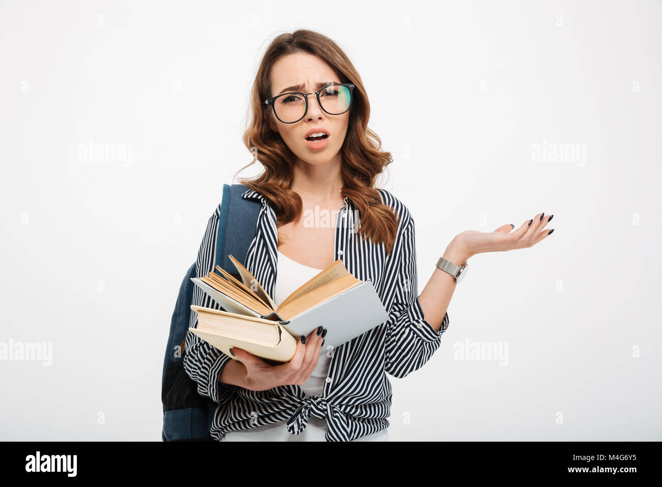 Image of confused young lady student standing isolated over white wall ...