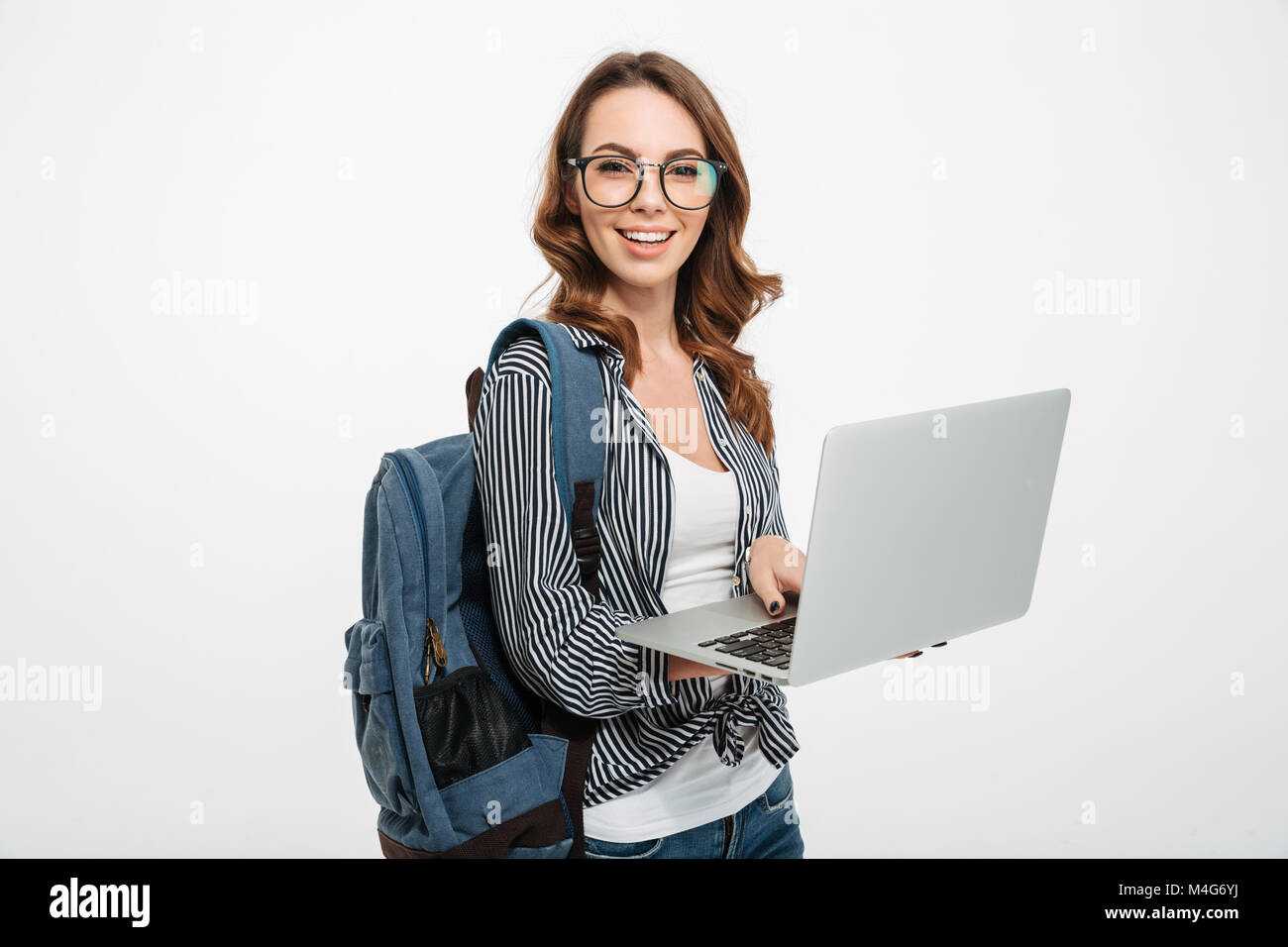 Photo of cute cheerful young lady student standing isolated over white ...
