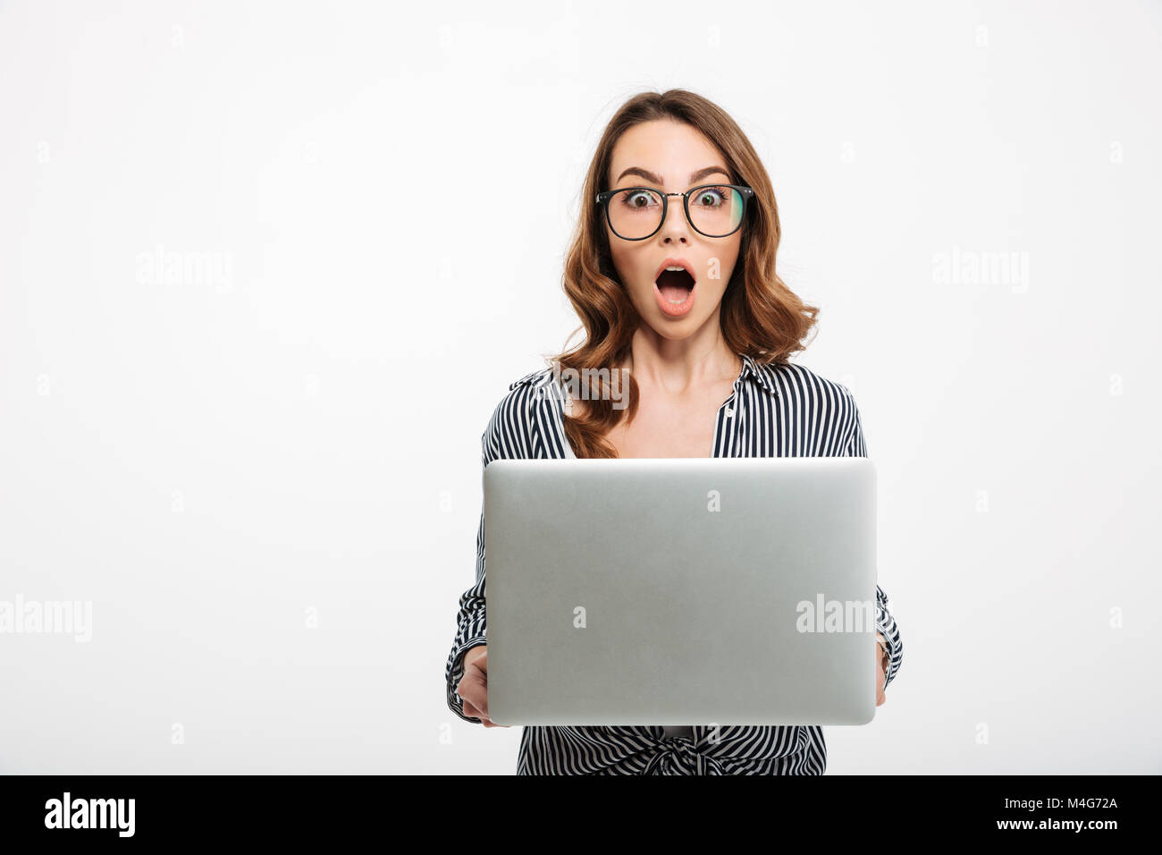 Image of shocked young lady student standing isolated over white wall ...