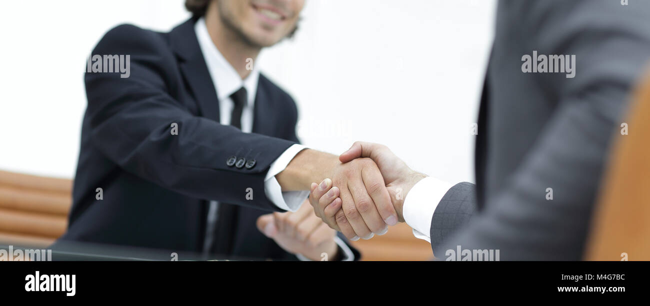 handshake Manager and the client sitting in the office Stock Photo - Alamy