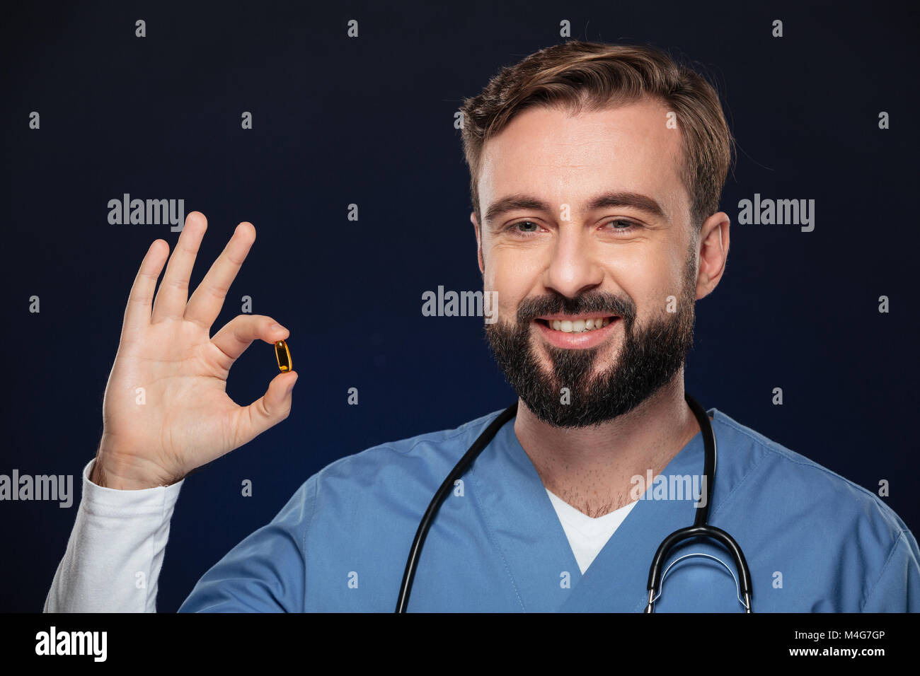 Portrait of a smiling male doctor dressed in uniform with stethoscope ...