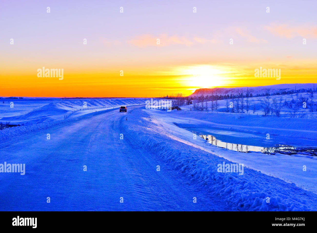 Car driving on the icy plateau at sunset in winter in Iceland Stock ...
