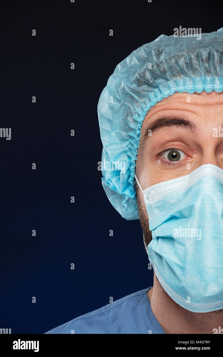 Close up half portrait of a surprised male surgeon's face wearing face ...