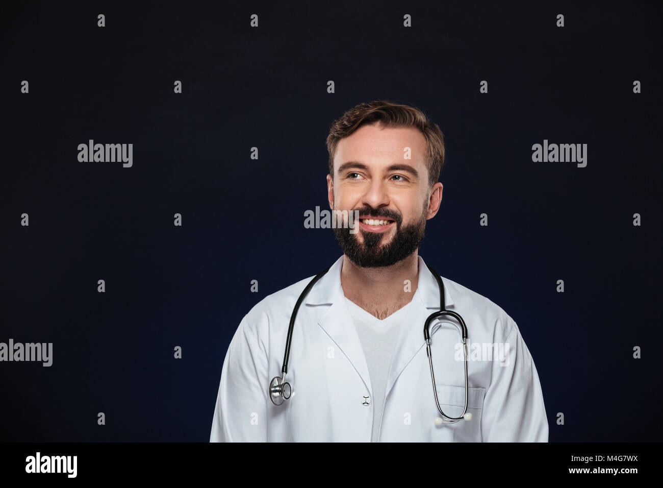 Portrait of a handsome male doctor dressed in uniform with stethoscope ...