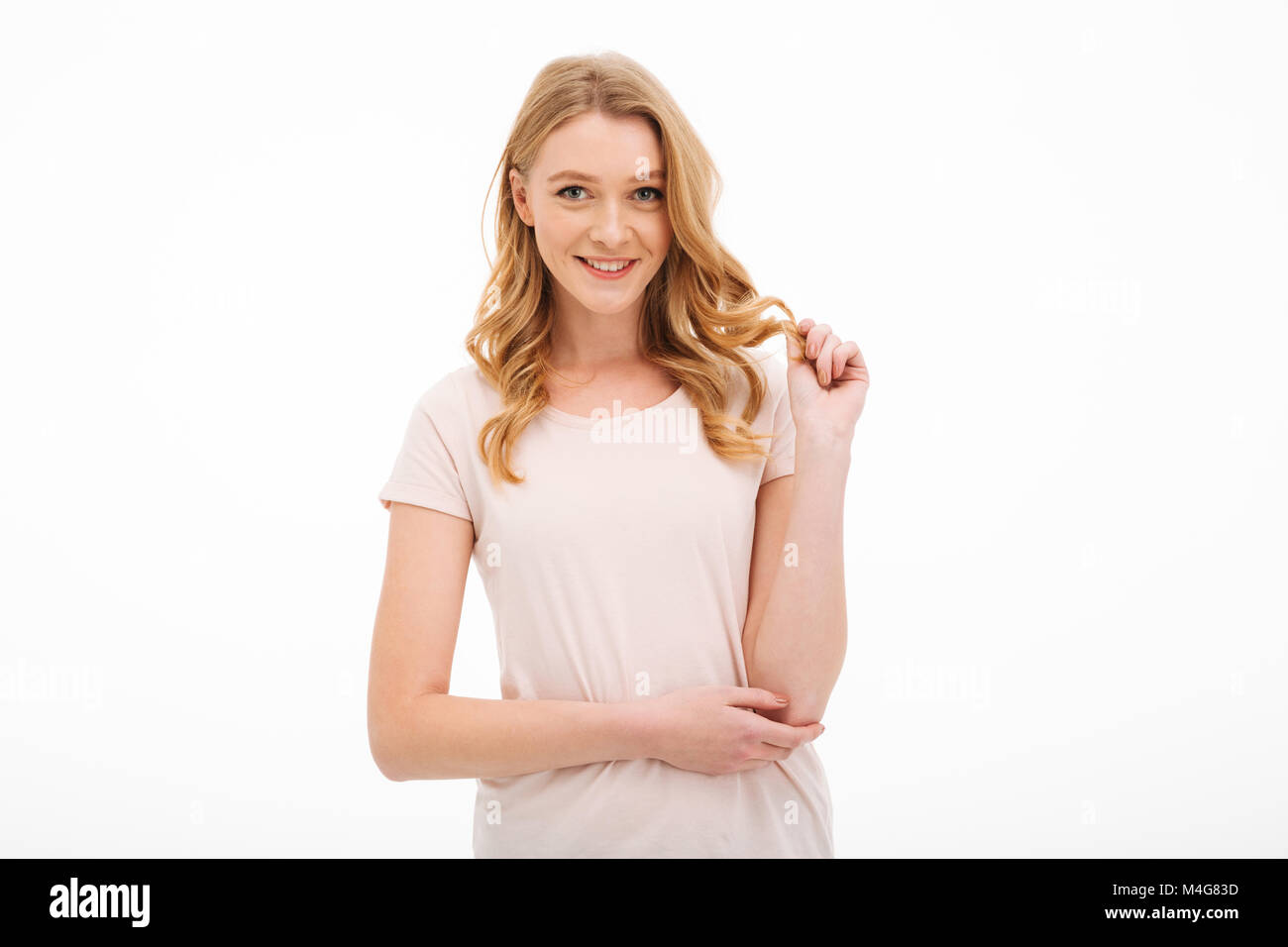 Image of pretty young woman standing isolated over white background ...