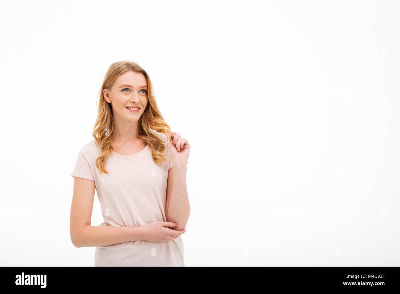 Image of pretty young woman standing isolated over white background ...
