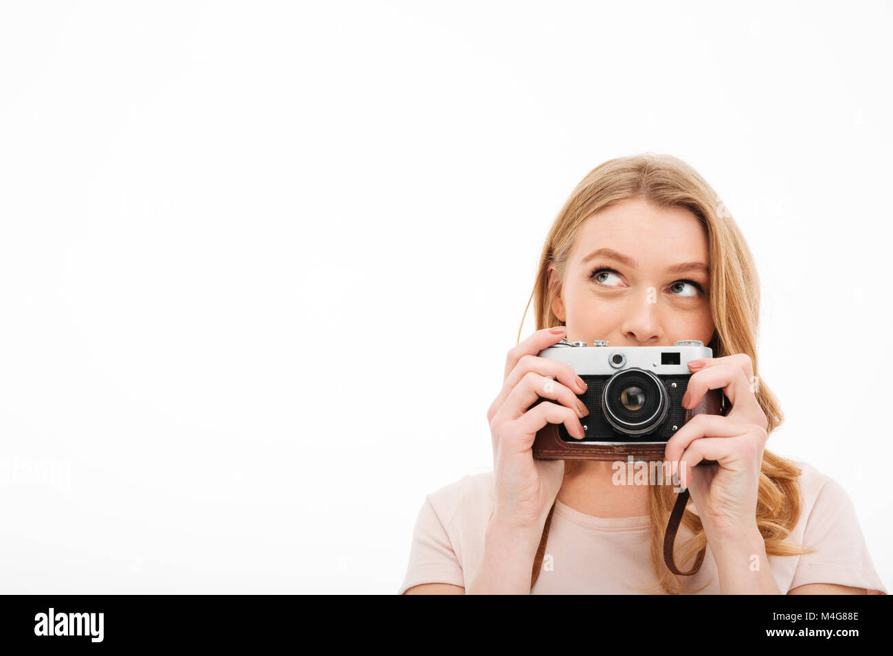 Photo of cute young woman standing isolated over white background ...