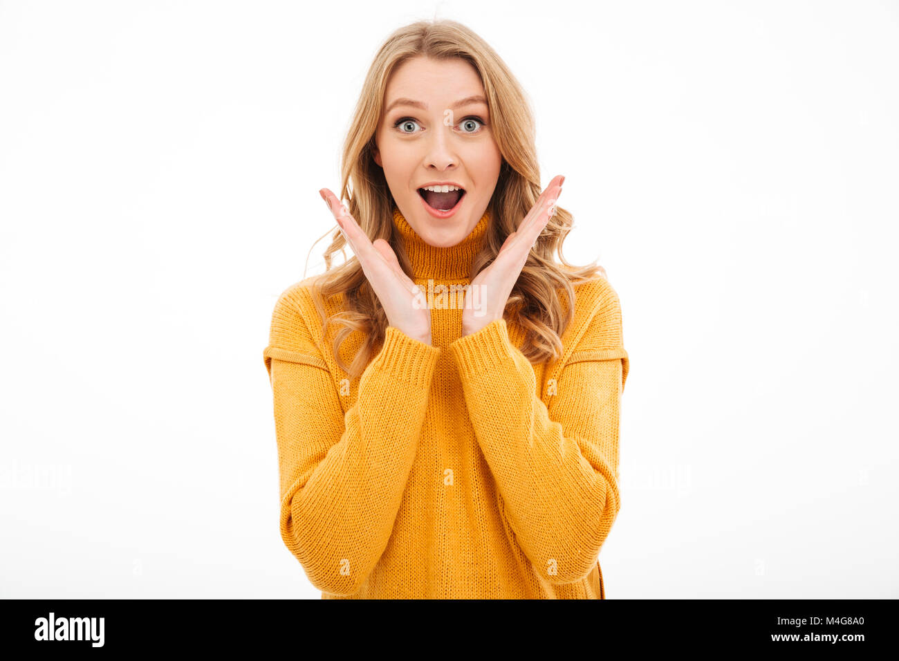 Photo of beautiful young surprised woman standing isolated over white ...