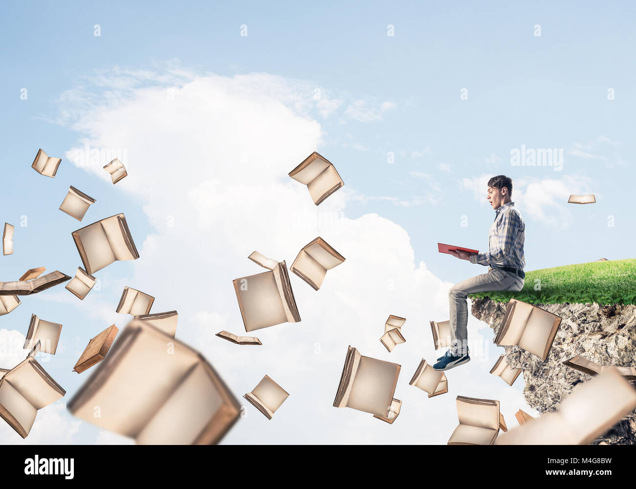Man reading book and many of them flying in air Stock Photo - Alamy