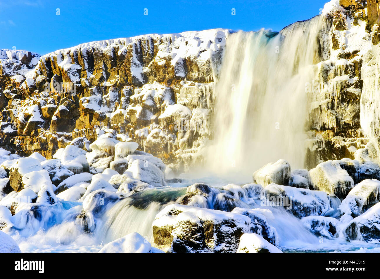 View of Oxararfoss waterfall in winter at Thingvellir National Park in ...