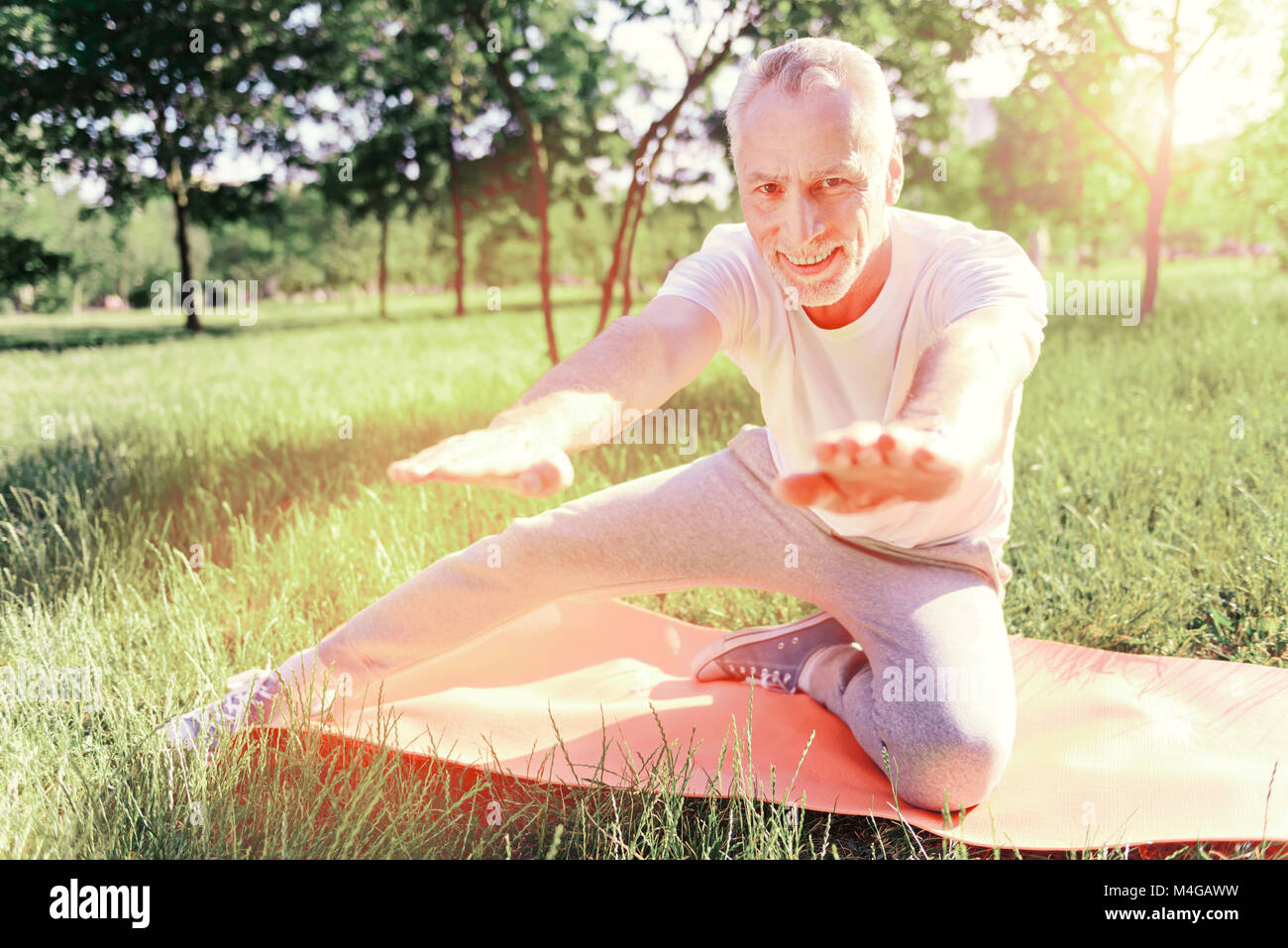 Excited man keeping hand forward Stock Photo - Alamy