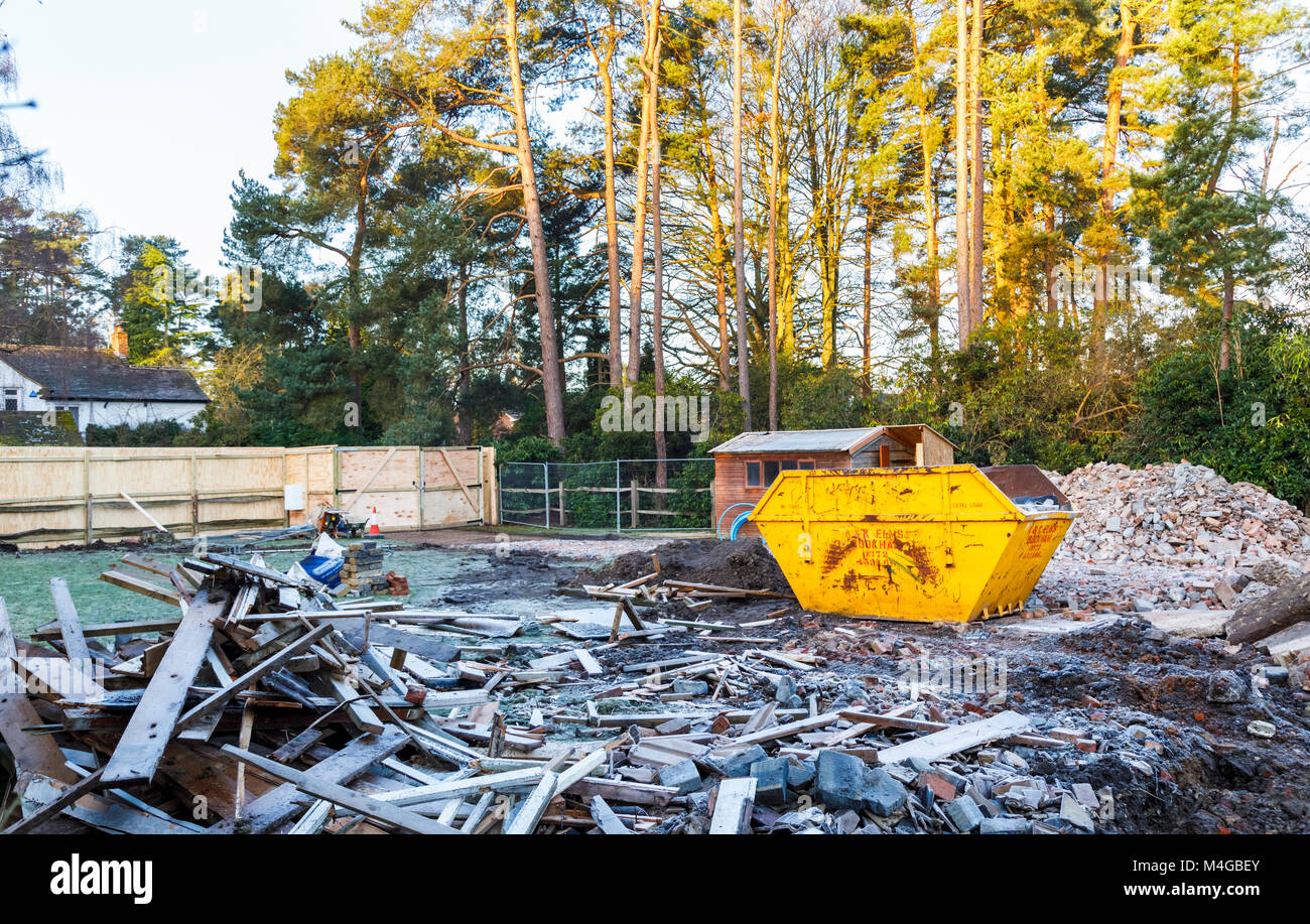 Real estate construction site: yellow skip in the remains of the ...