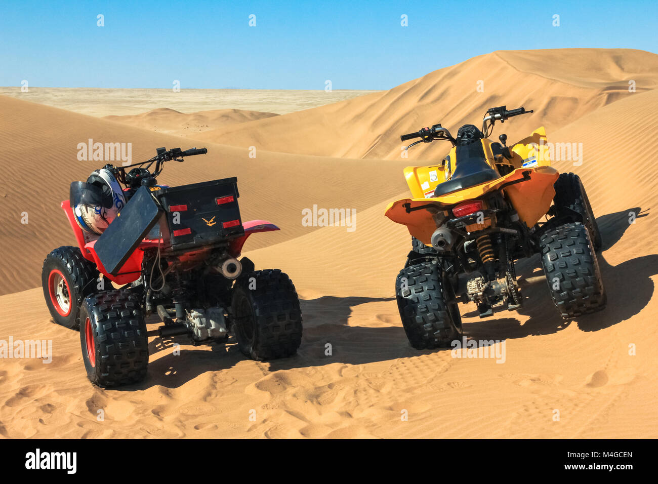 Quad driving in sand desert. Two ATV in middle of nowhere Stock Photo ...