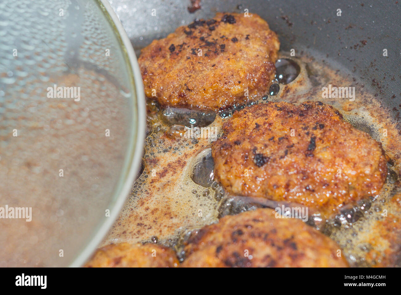 fried cutlets in a frying pan cooking Stock Photo - Alamy