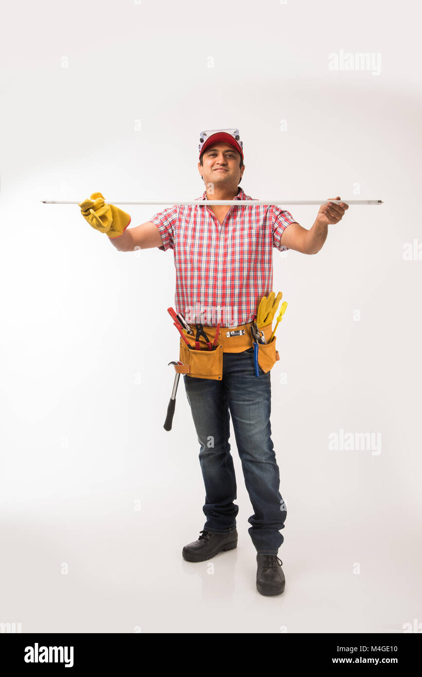 Indian electrician engineer in action with wire cutter, drilling ...