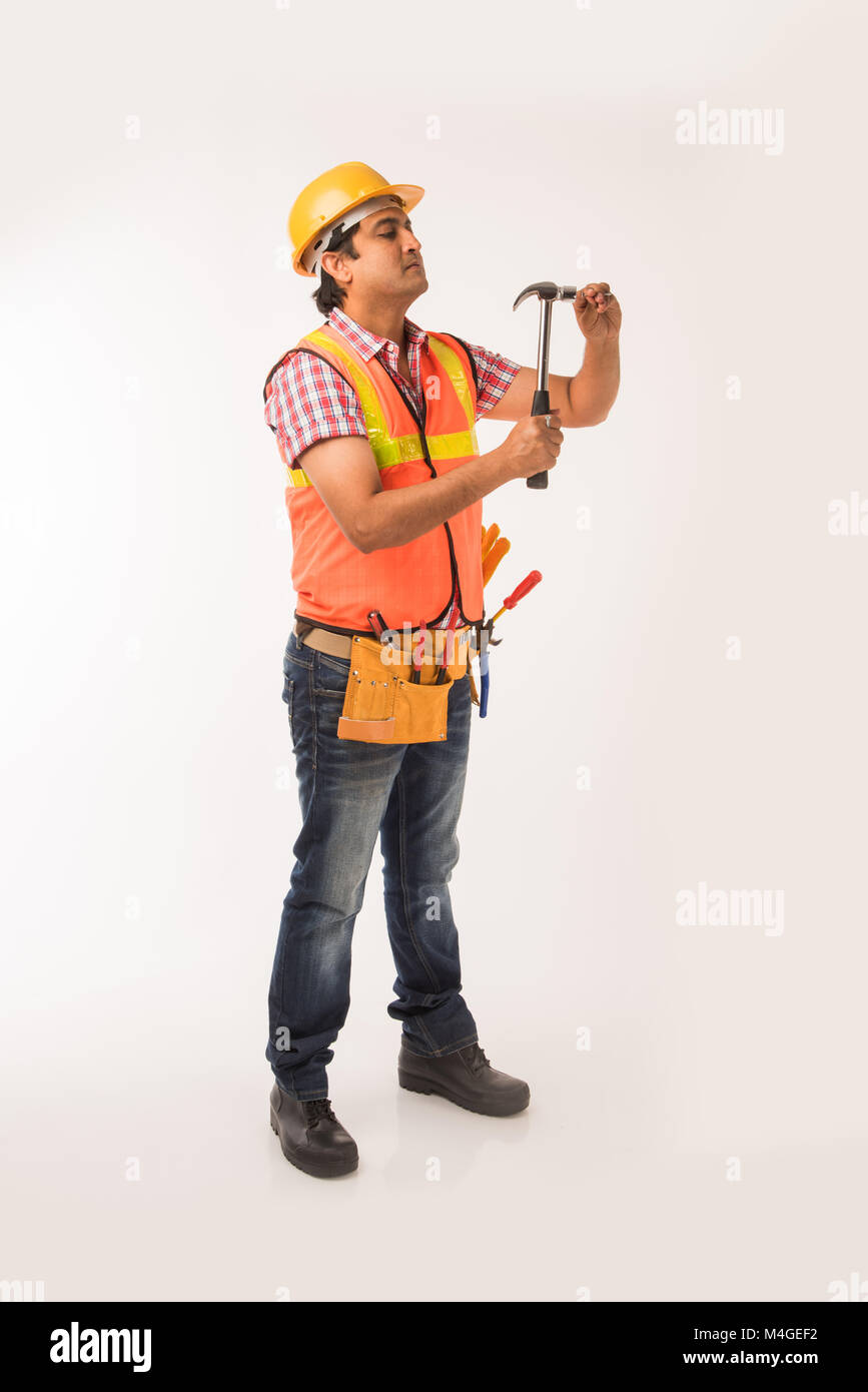 Indian electrician engineer in action with wire cutter, drilling ...