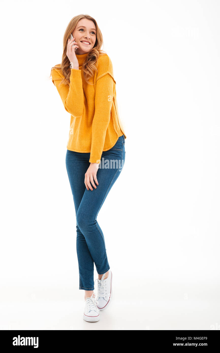 Image of happy young lady standing isolated over white background ...