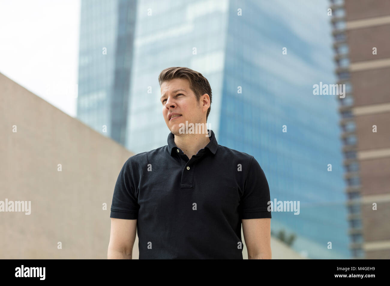 Man standing near buildings hi-res stock photography and images - Alamy