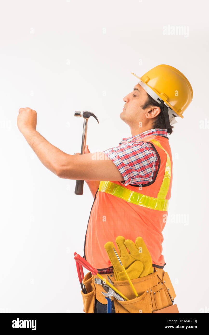 Indian electrician engineer in action with wire cutter, drilling ...