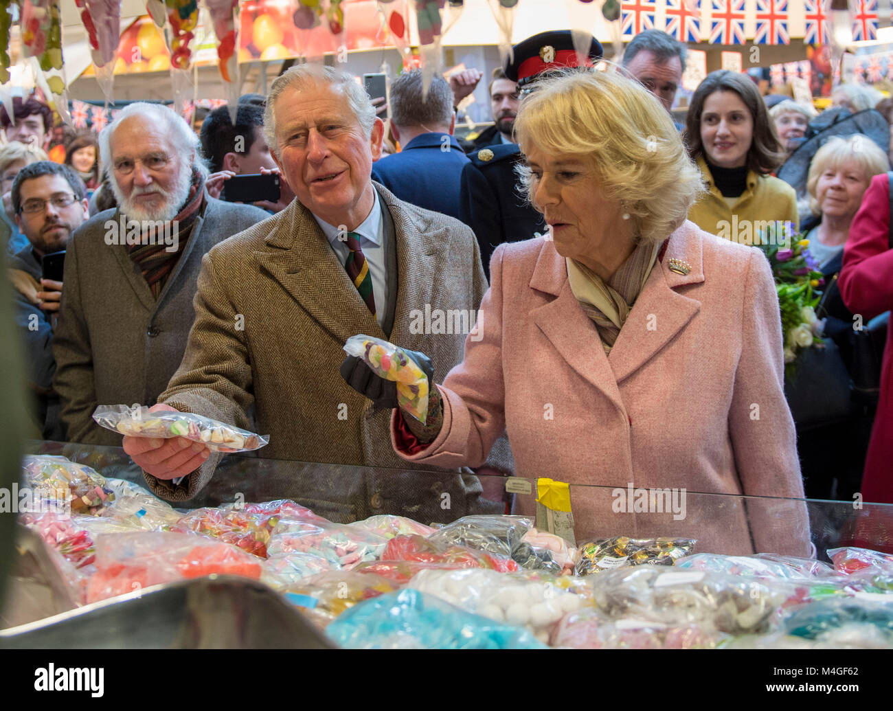 The Prince of Wales and the Duchess of Cornwall are given sweets during ...