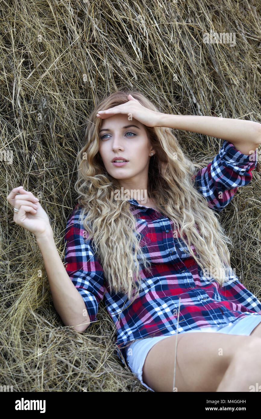 Young blonde country girl near haystacks Stock Photo - Alamy