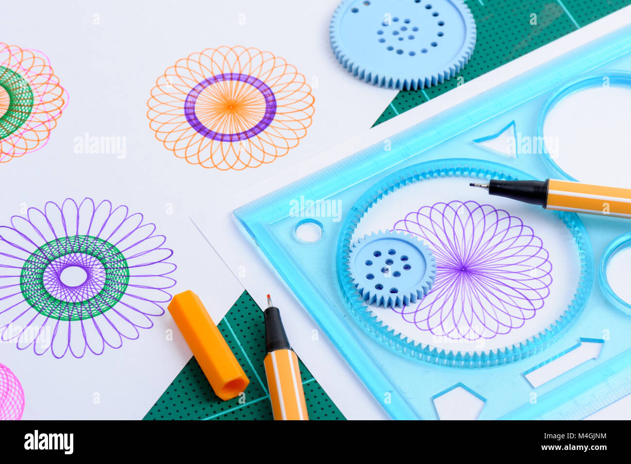 Drawing the spirograph pattern with spirograph kit Stock Photo - Alamy
