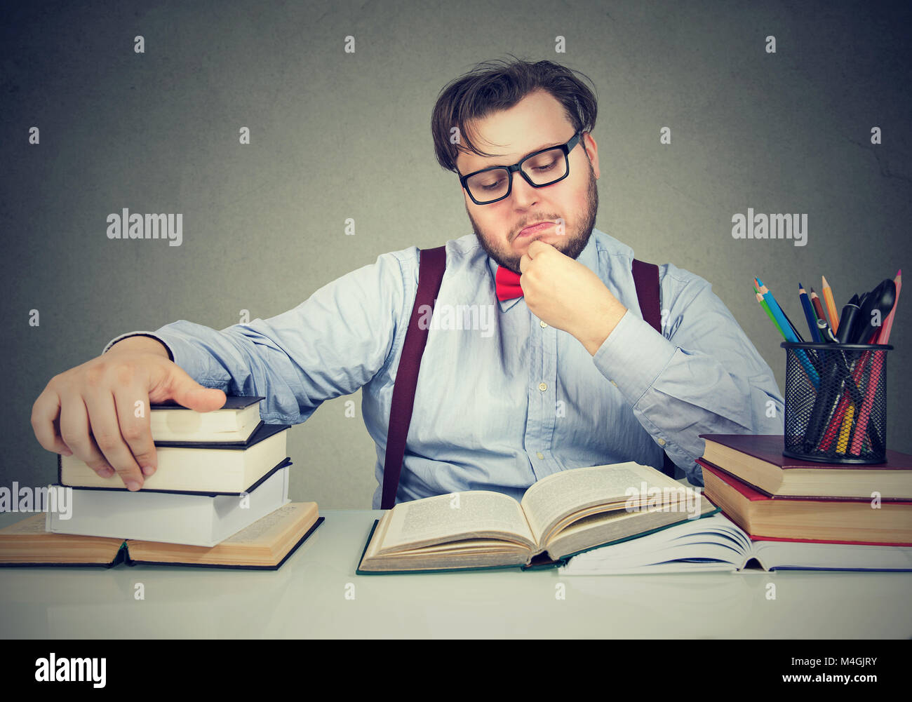 Professional man sitting desk reading hi-res stock photography and ...