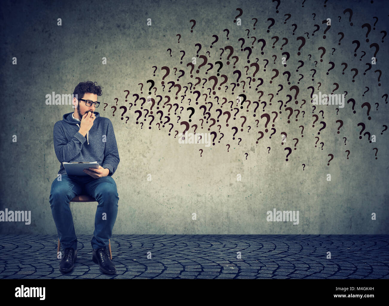 Anxious man sitting with resume anticipating interview, having plenty ...