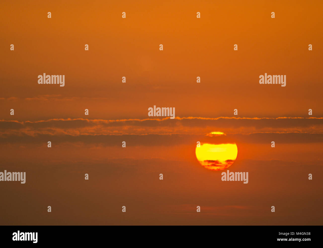sunriese with bright sun in an orange sky Stock Photo - Alamy