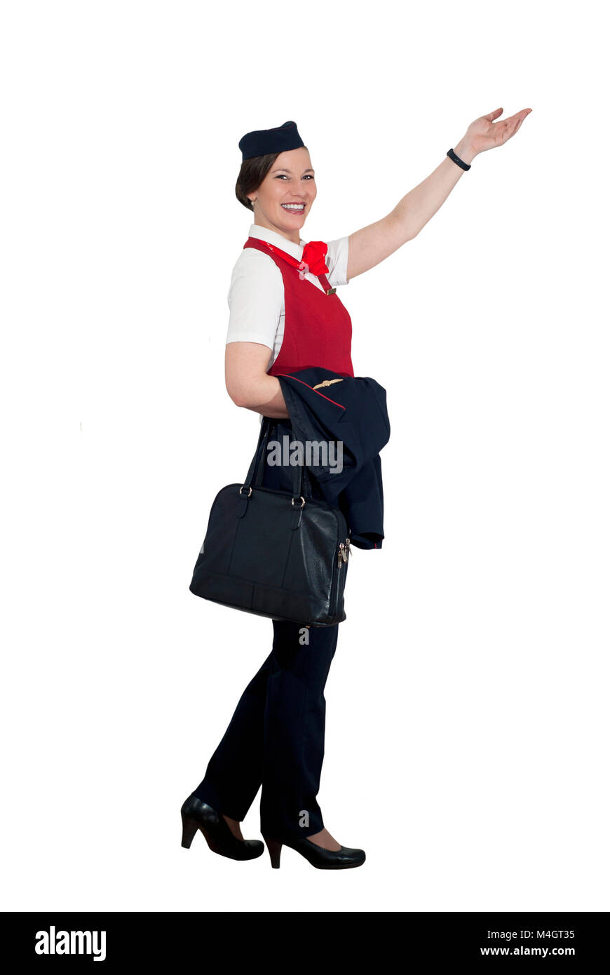 stewardess in full growth on a white background steps, smiles and shows ...