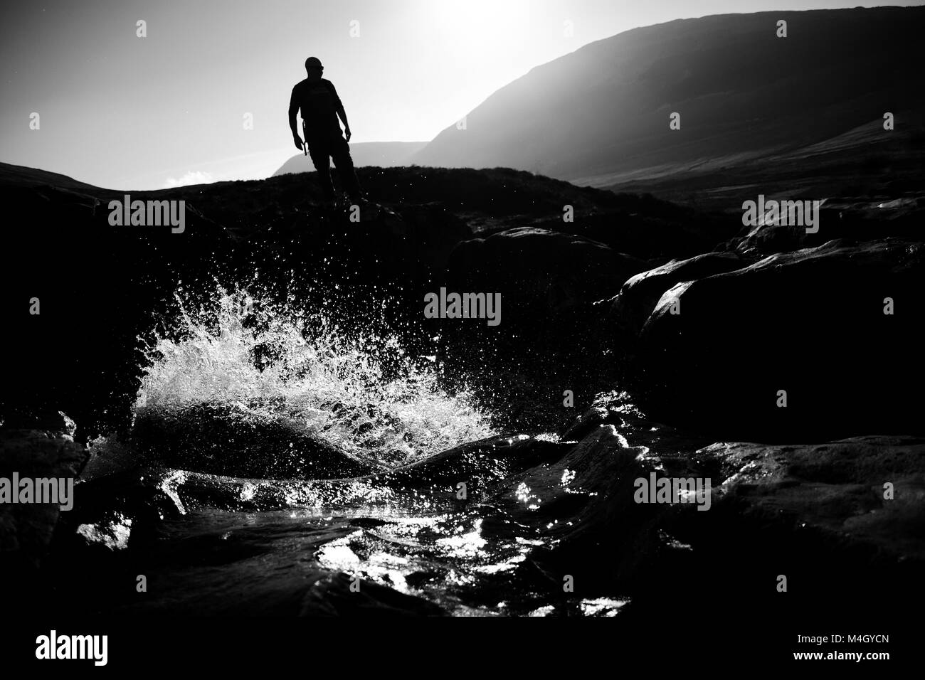 A mysterious silhouette above a small spray of water from a rapid ...