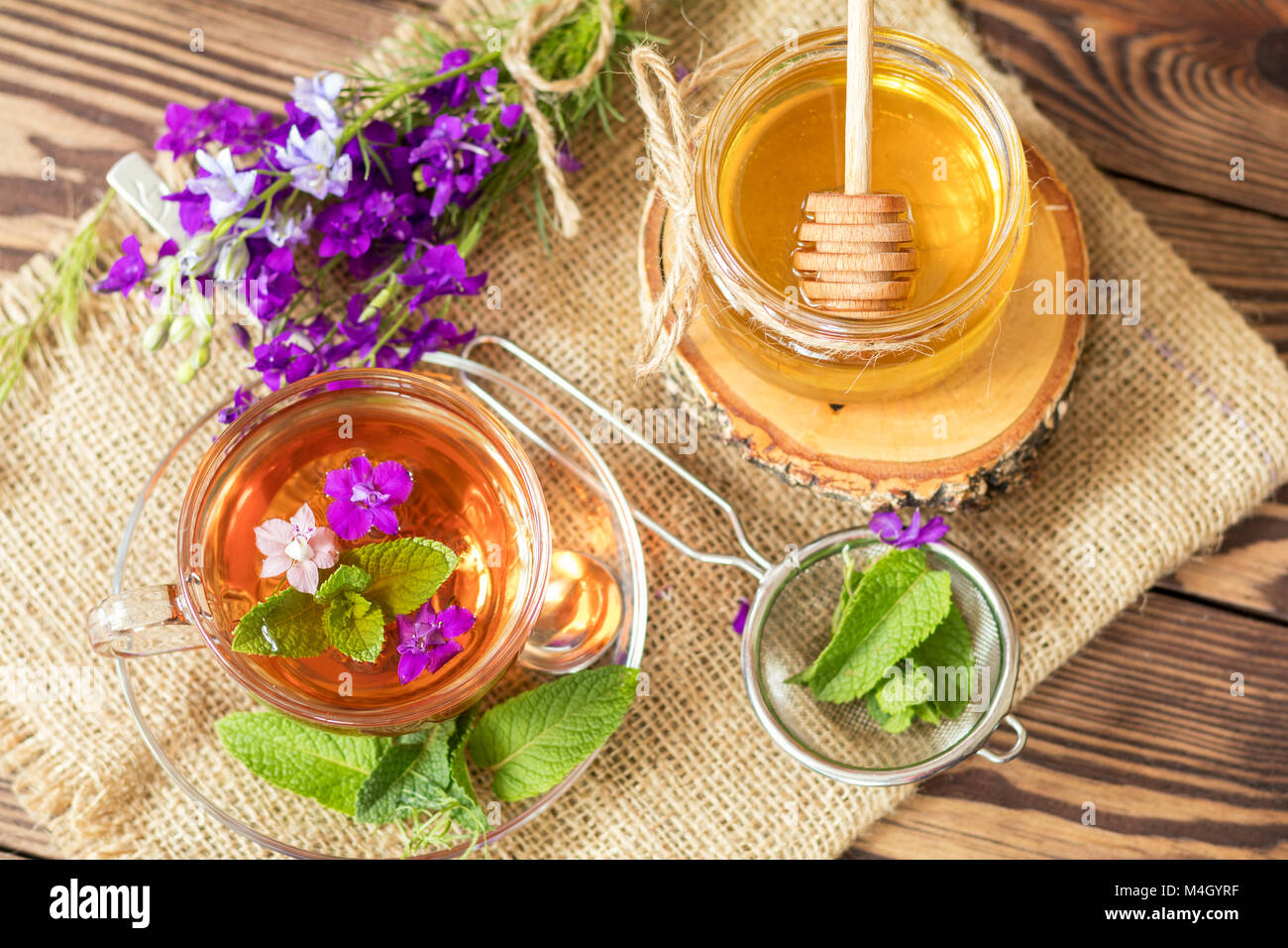Glass cup of summer tea with herbs Stock Photo - Alamy