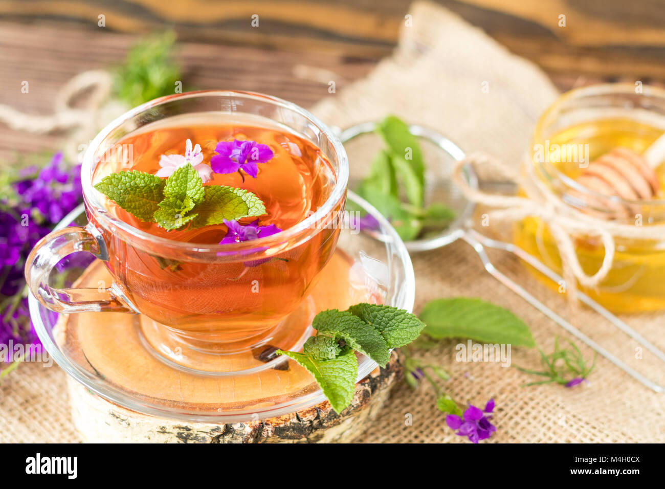 Glass cup of summer tea with herbs Stock Photo - Alamy
