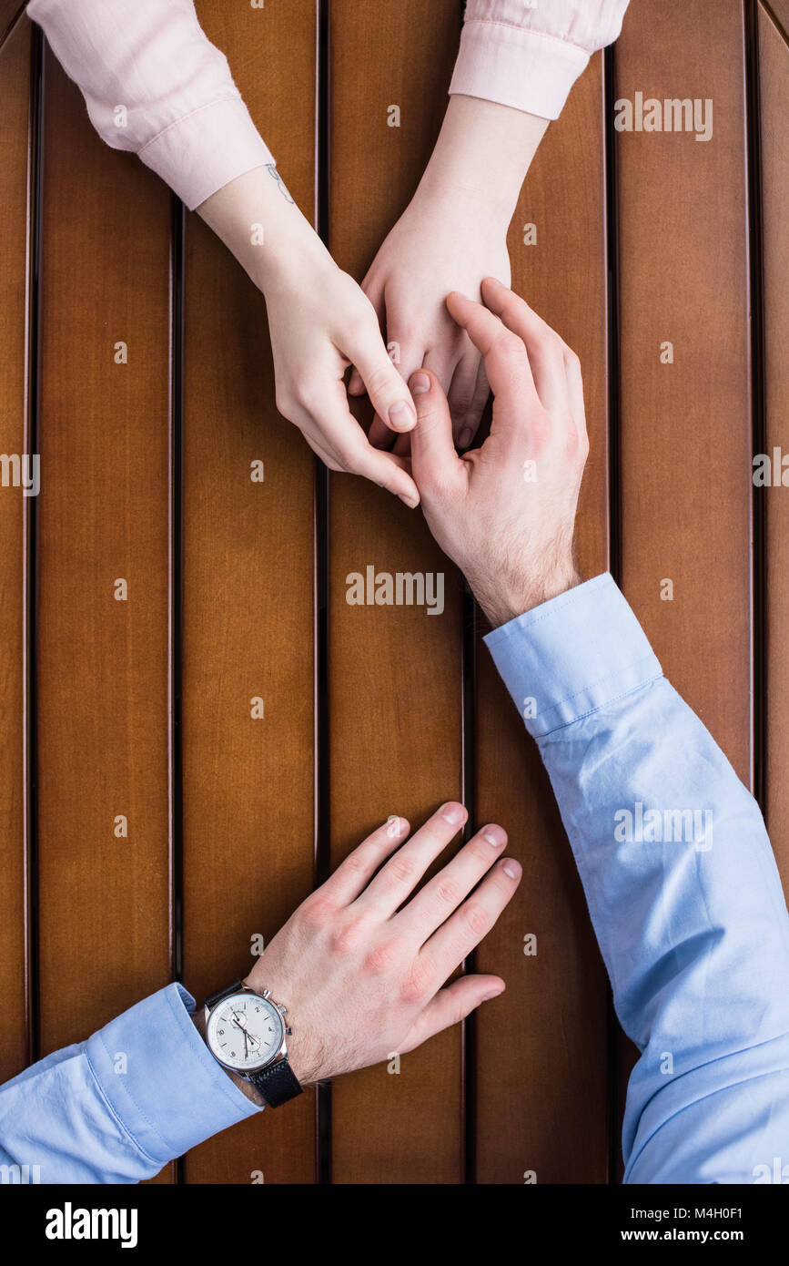 cropped image of man palming hand on girlfriends hands Stock Photo - Alamy