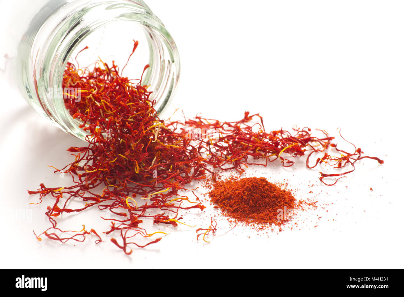 Pistils and red powder of Abruzzo saffron on white background in still ...