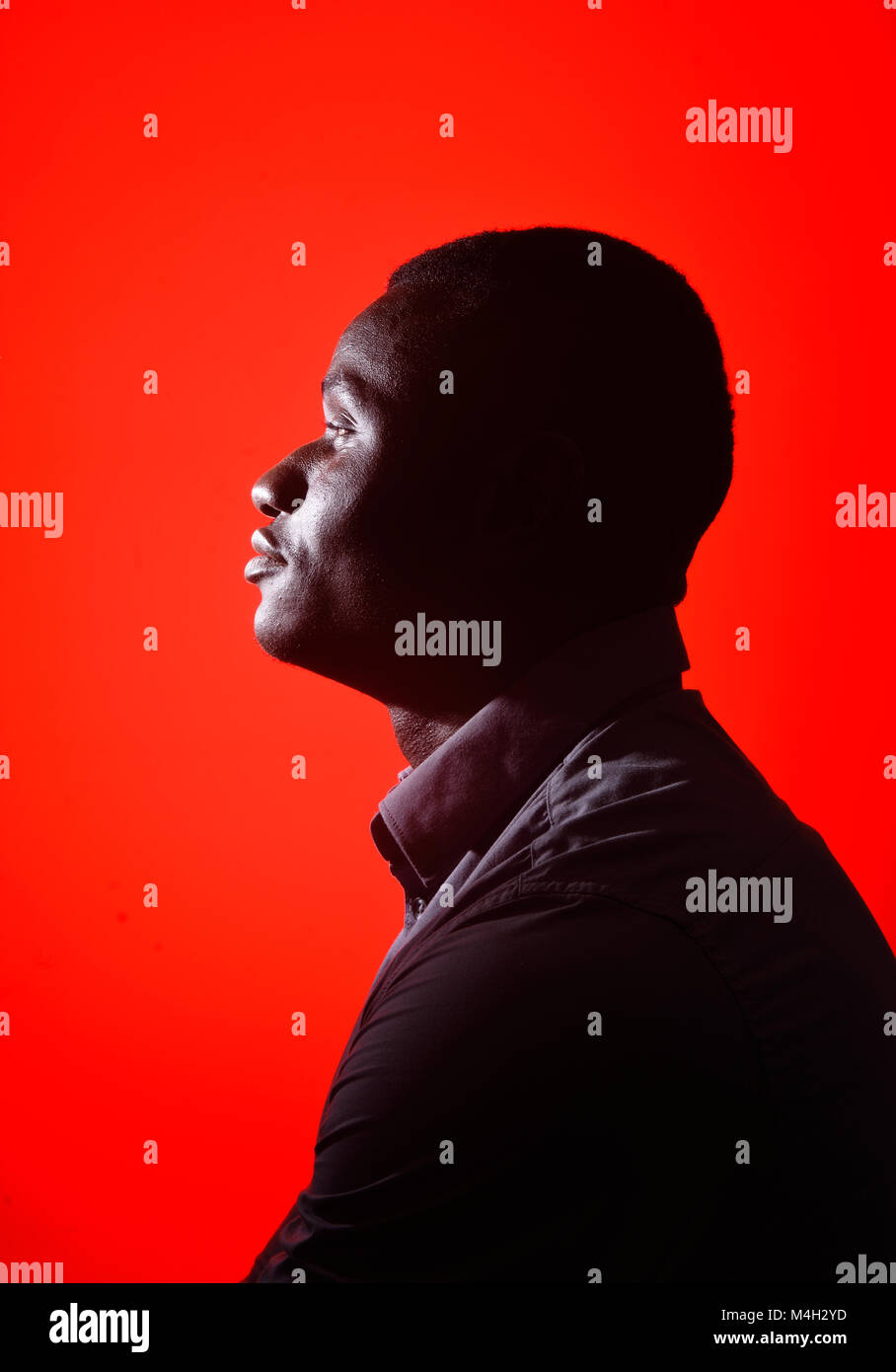 portrait of a african man on red background Stock Photo - Alamy