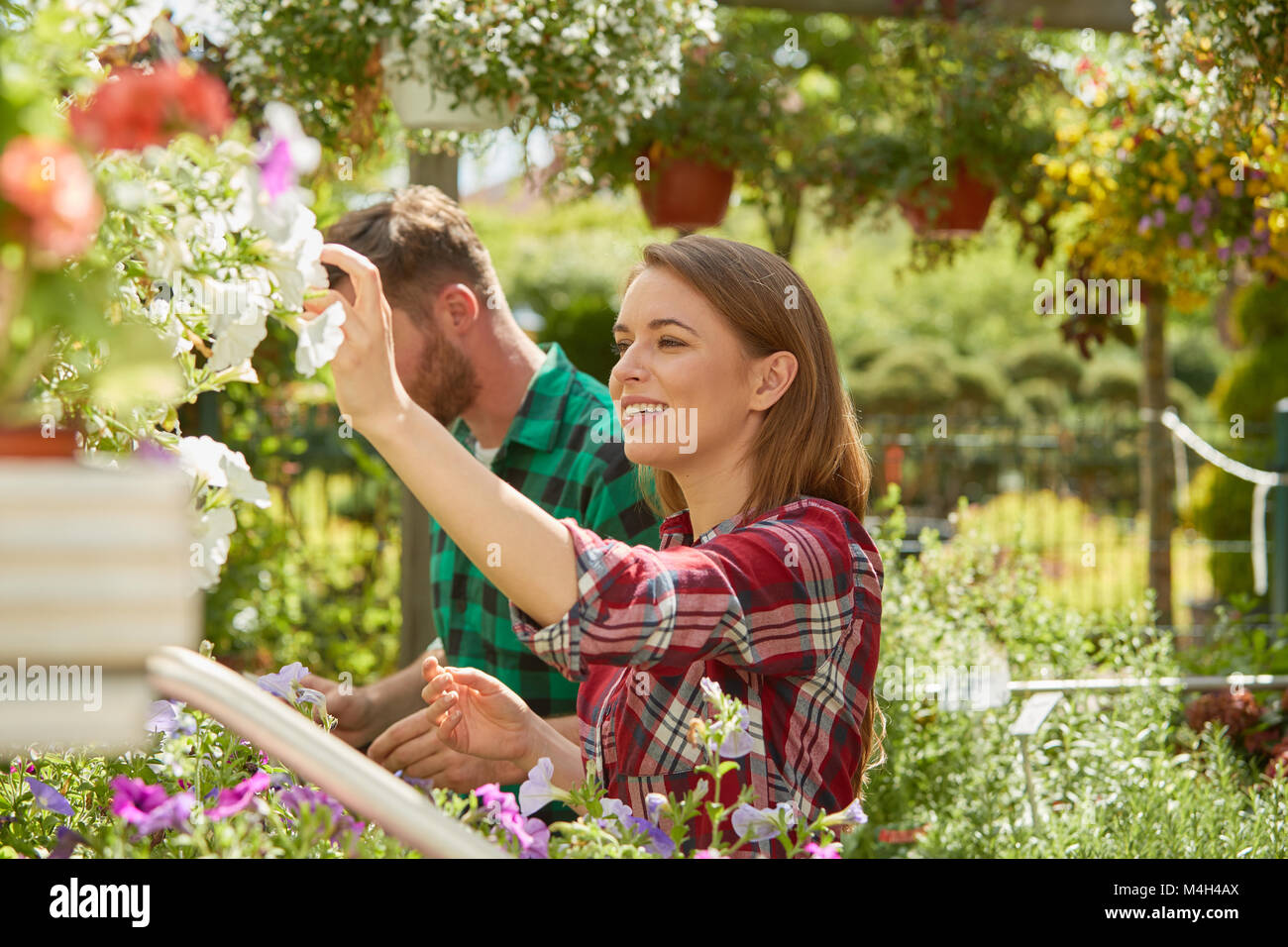 Man and woman with flowers in garden Stock Photo - Alamy