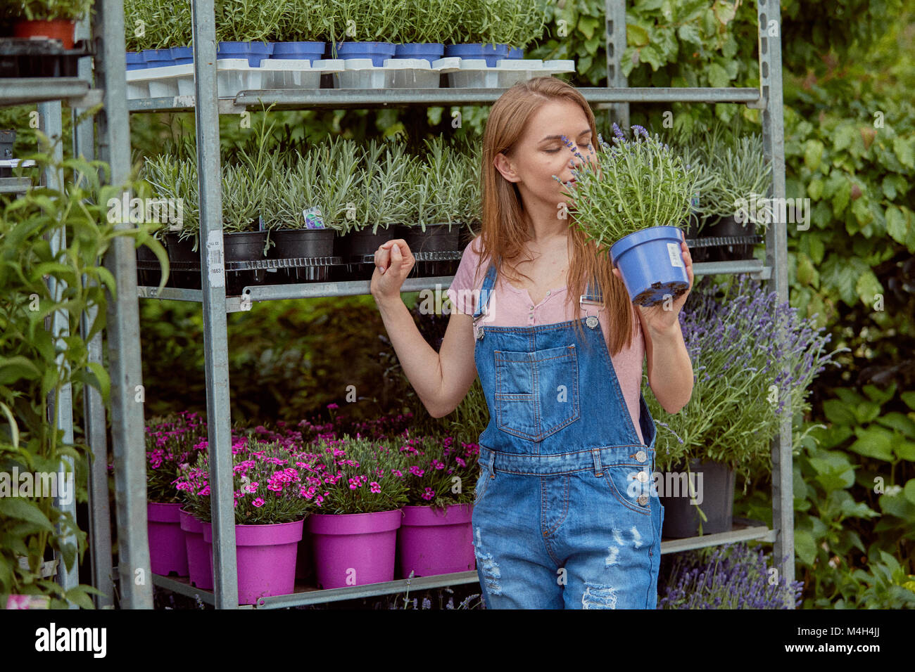 Excited woman with potted flower Stock Photo - Alamy