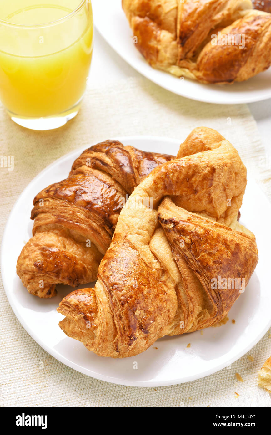 Fresh hot croissants and orange juice for breakfast Stock Photo - Alamy
