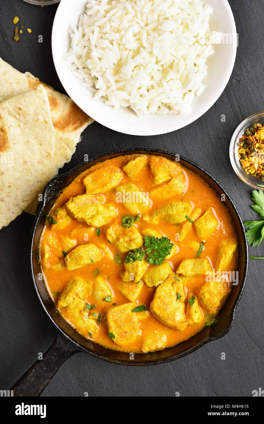 Indian chicken curry on black stone background. Top view, flat lay ...