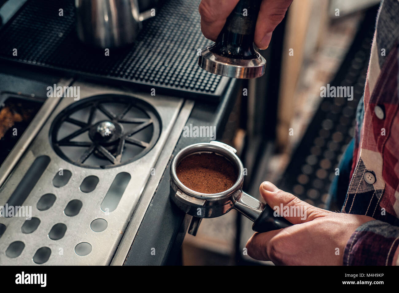 Close up image of a man making coffee in a professional coffee machine ...