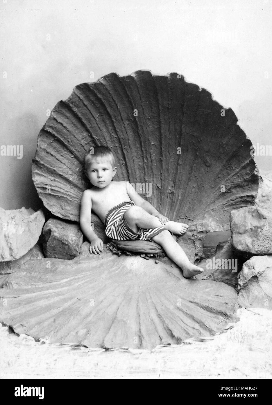 A little boy poses sitting in an oversized shell in a studio in Aachen ...