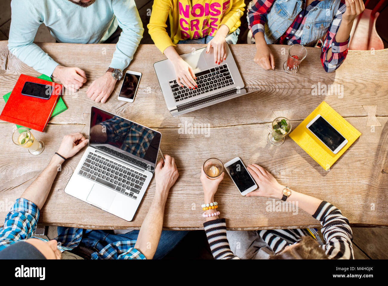 People working with laptops and phones Stock Photo - Alamy