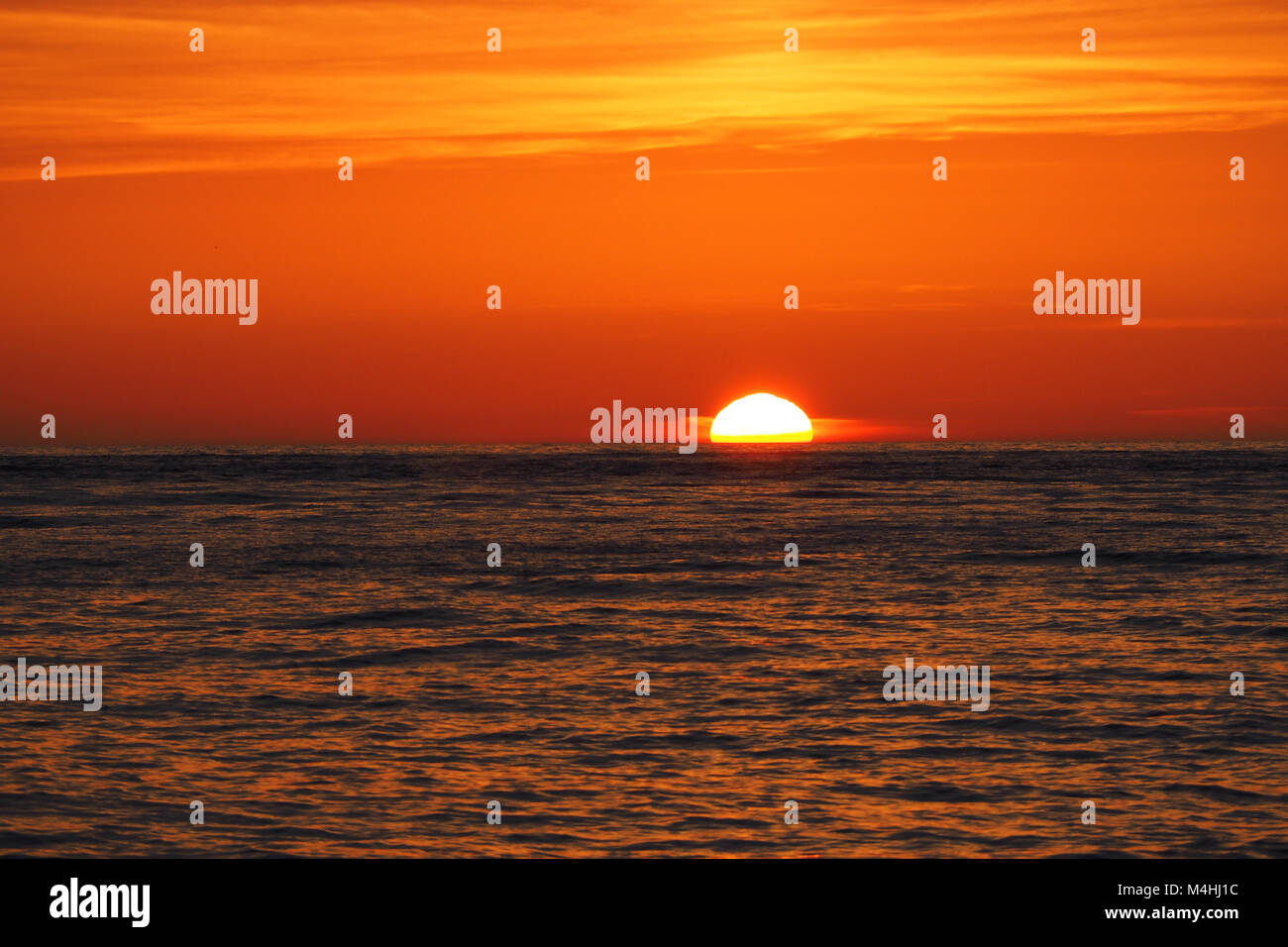Sunset at the ocean Stock Photo - Alamy