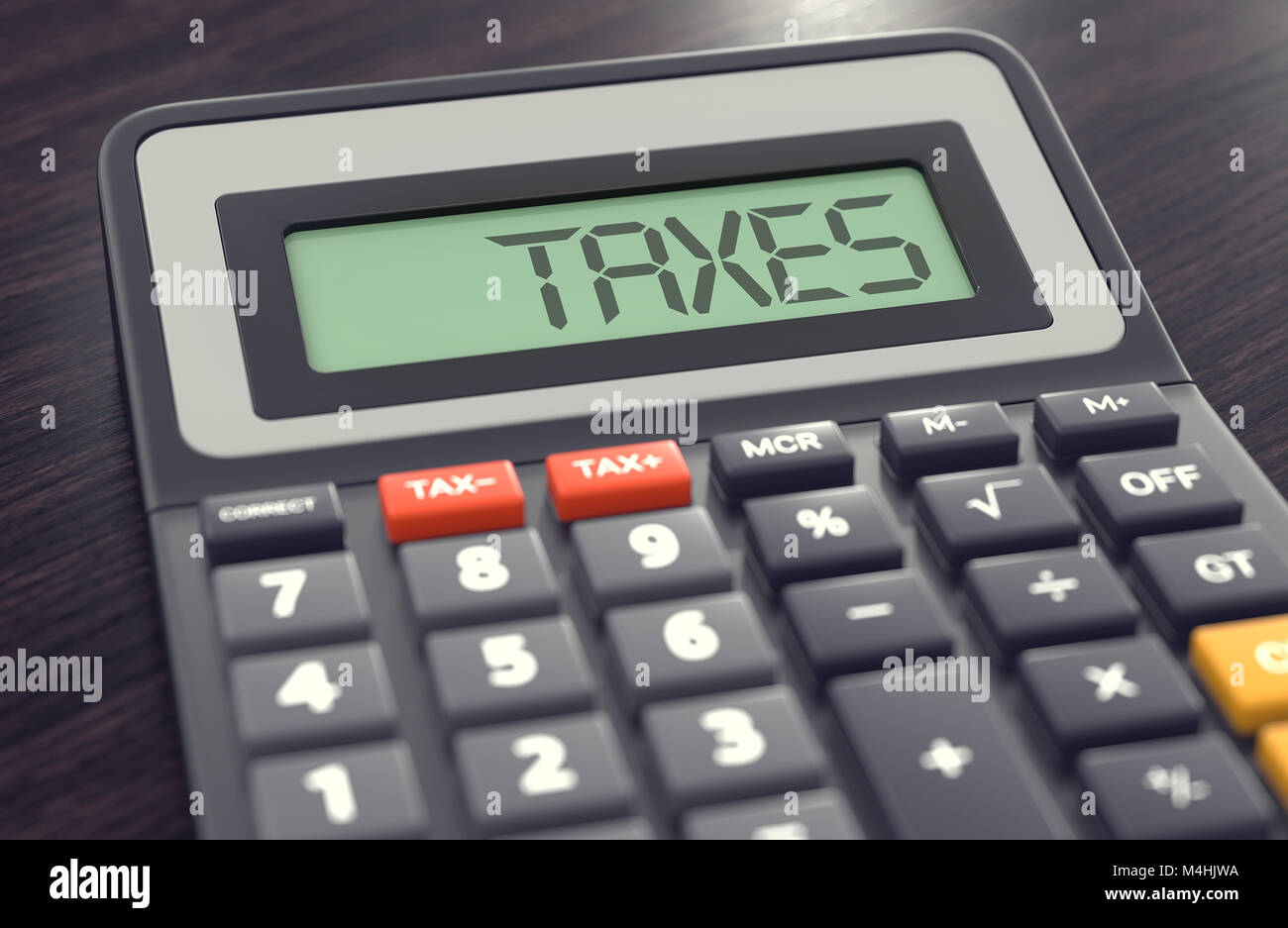 Calculator with the word TAXES on the display. Tax calculation concept ...