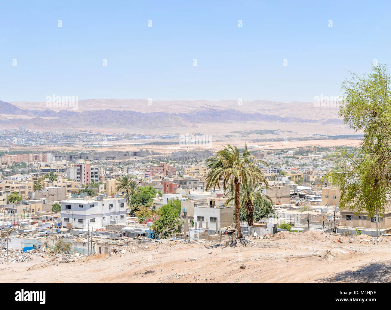 A view of Aqaba Jordan with the hills of Eilat in Israel and a blue sky ...