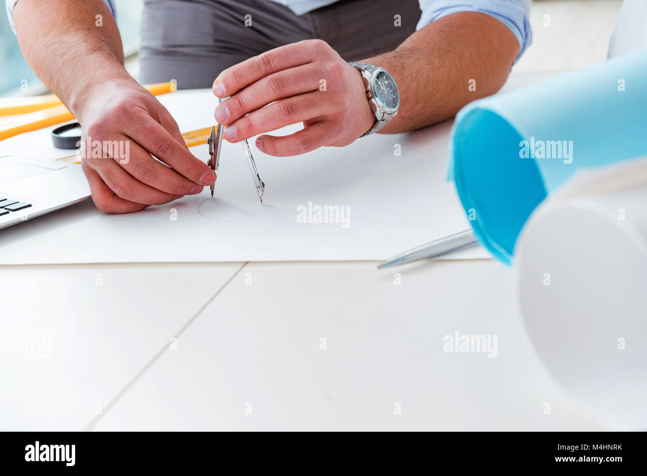 Male engineer working on drawings and blueprints Stock Photo - Alamy