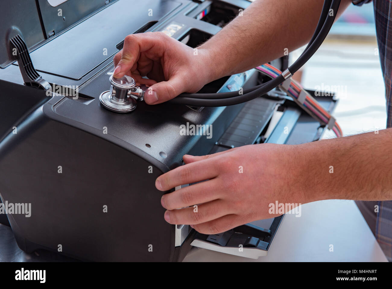 Repairman repairing broken color printer Stock Photo - Alamy
