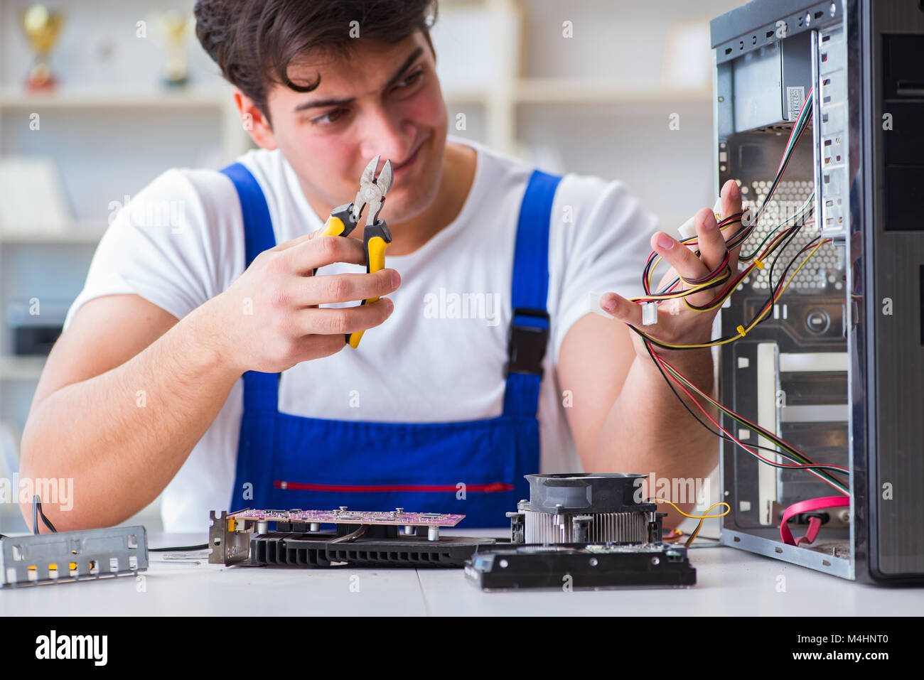 Computer repairman repairing desktop computer Stock Photo - Alamy